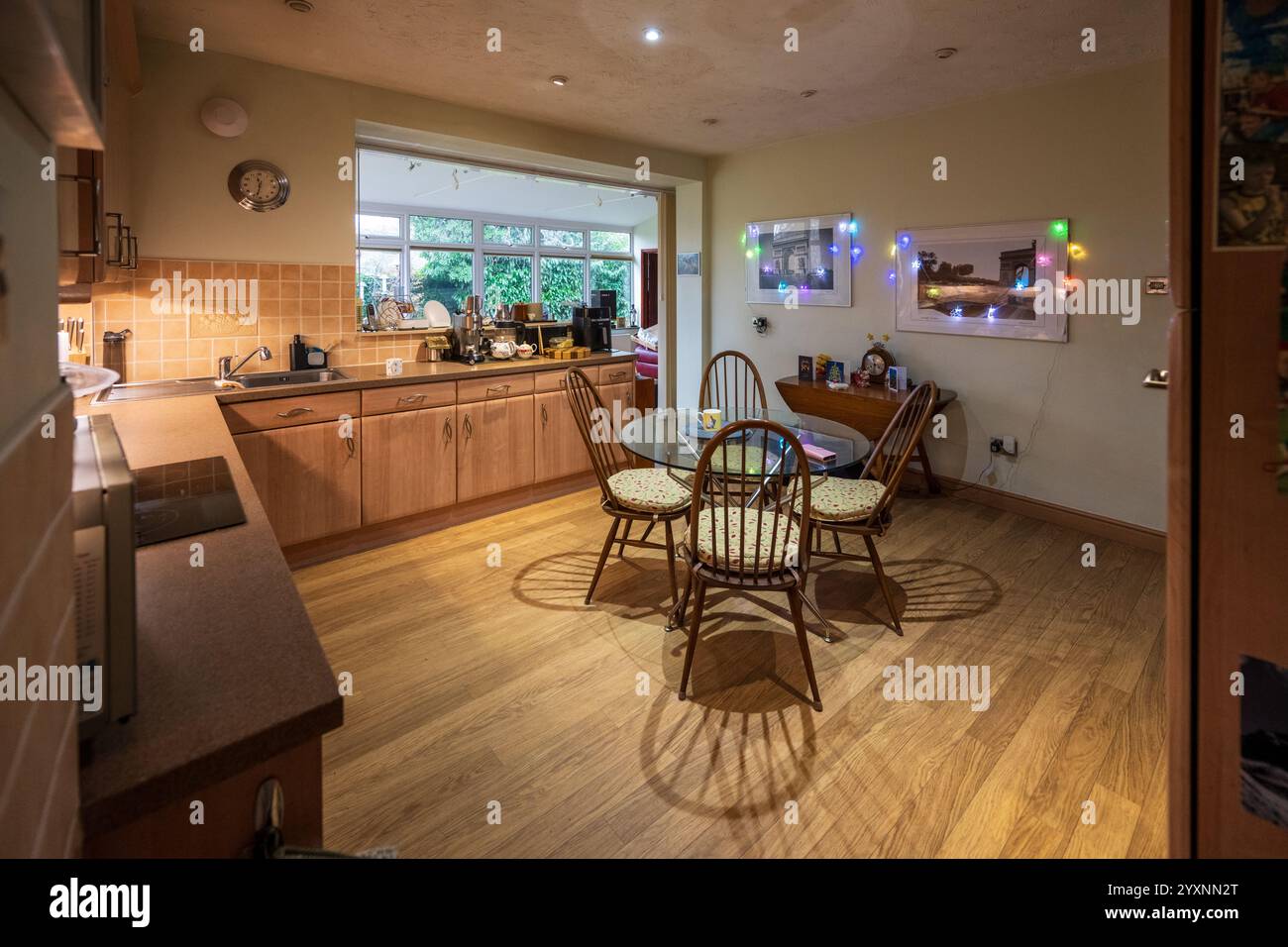 Large family kitchen with wooden effect floor Stock Photo - Alamy