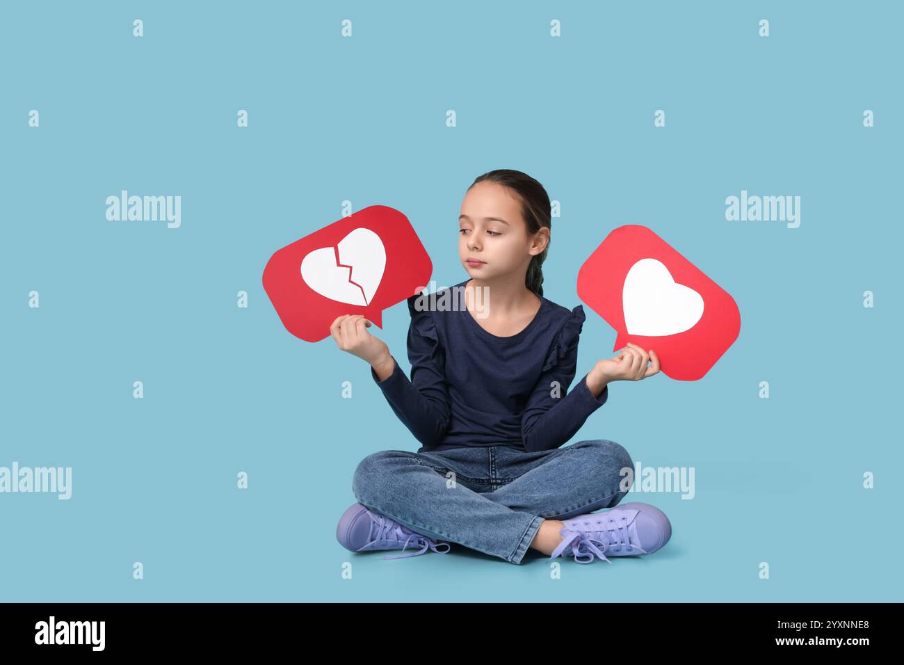 Little girl with heart like and dislike icons sitting on blue ...