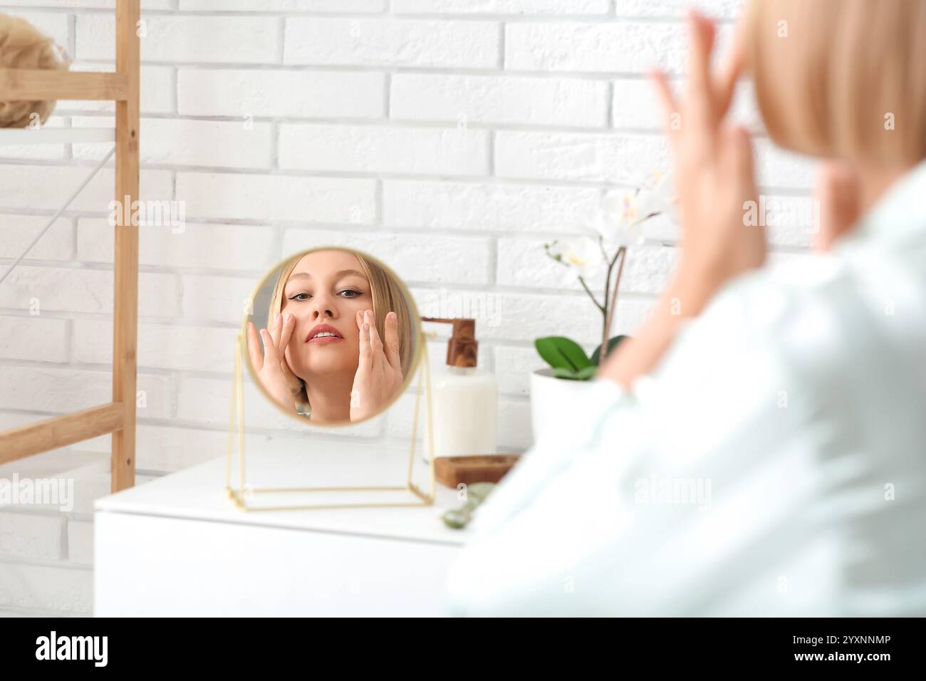 Woman doing face building exercise in bathroom Stock Photo - Alamy