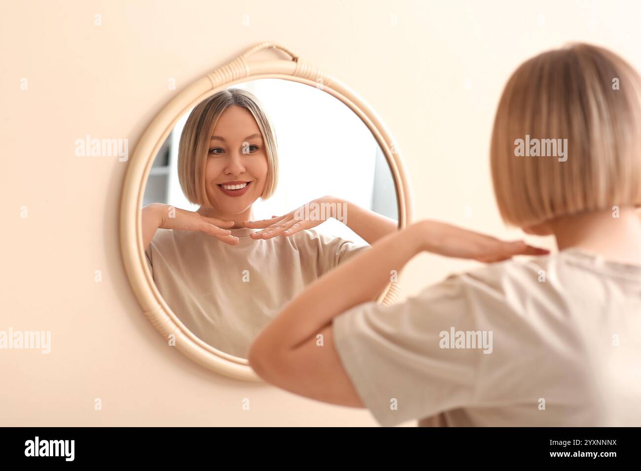 Woman doing face building exercise in bathroom Stock Photo - Alamy