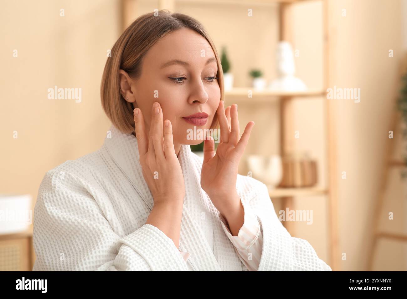 Woman doing face building exercise in bathroom Stock Photo - Alamy