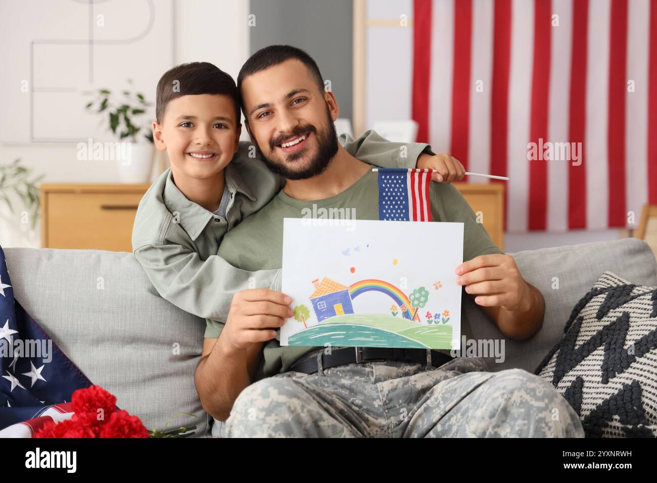 Little boy and his military father with drawing at home. Veterans Day ...