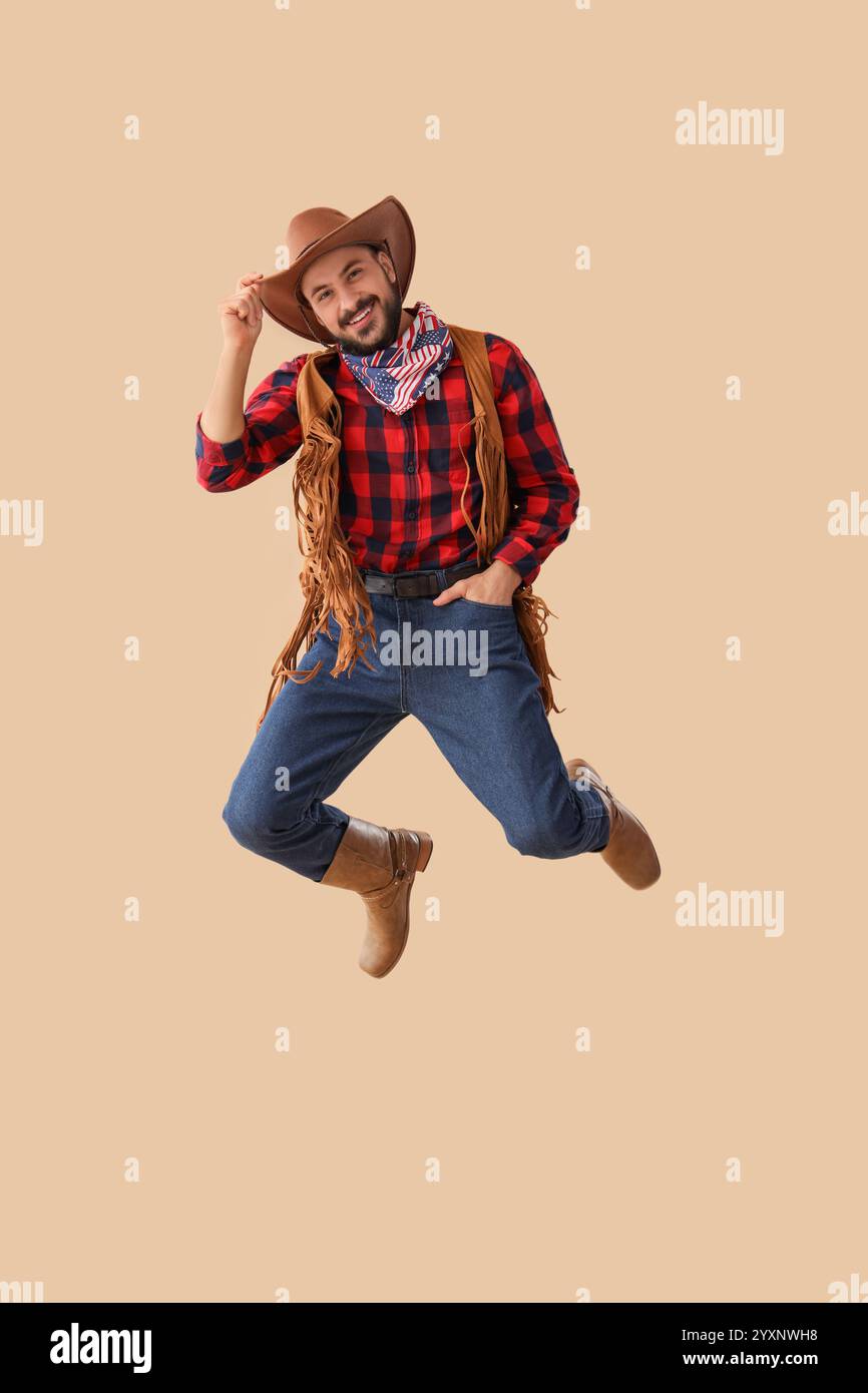 Jumping cowboy on beige background Stock Photo - Alamy