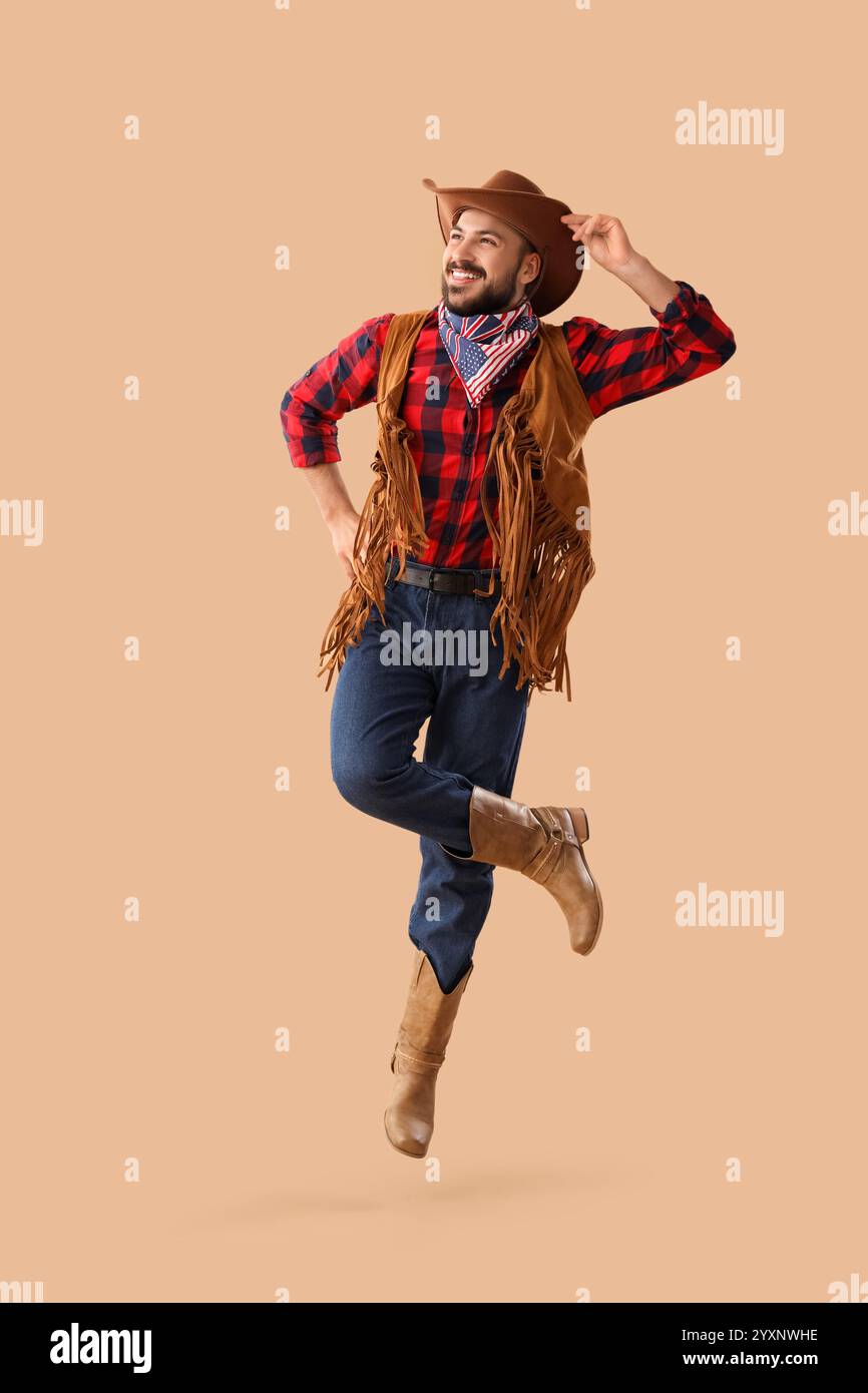 Jumping cowboy on beige background Stock Photo - Alamy