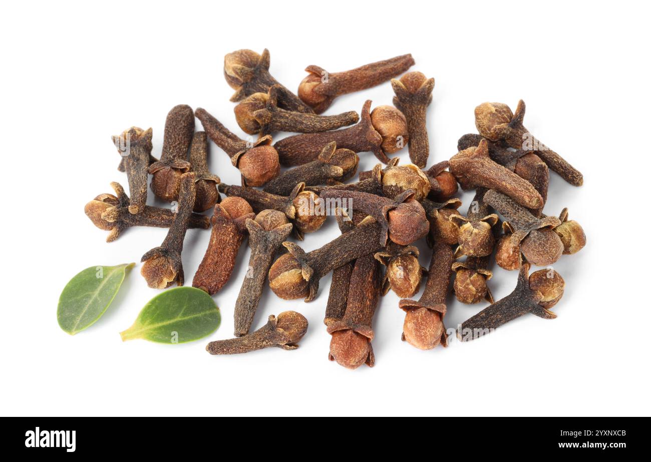 Pile of dry clove buds and green leaves on white background. Aromatic ...