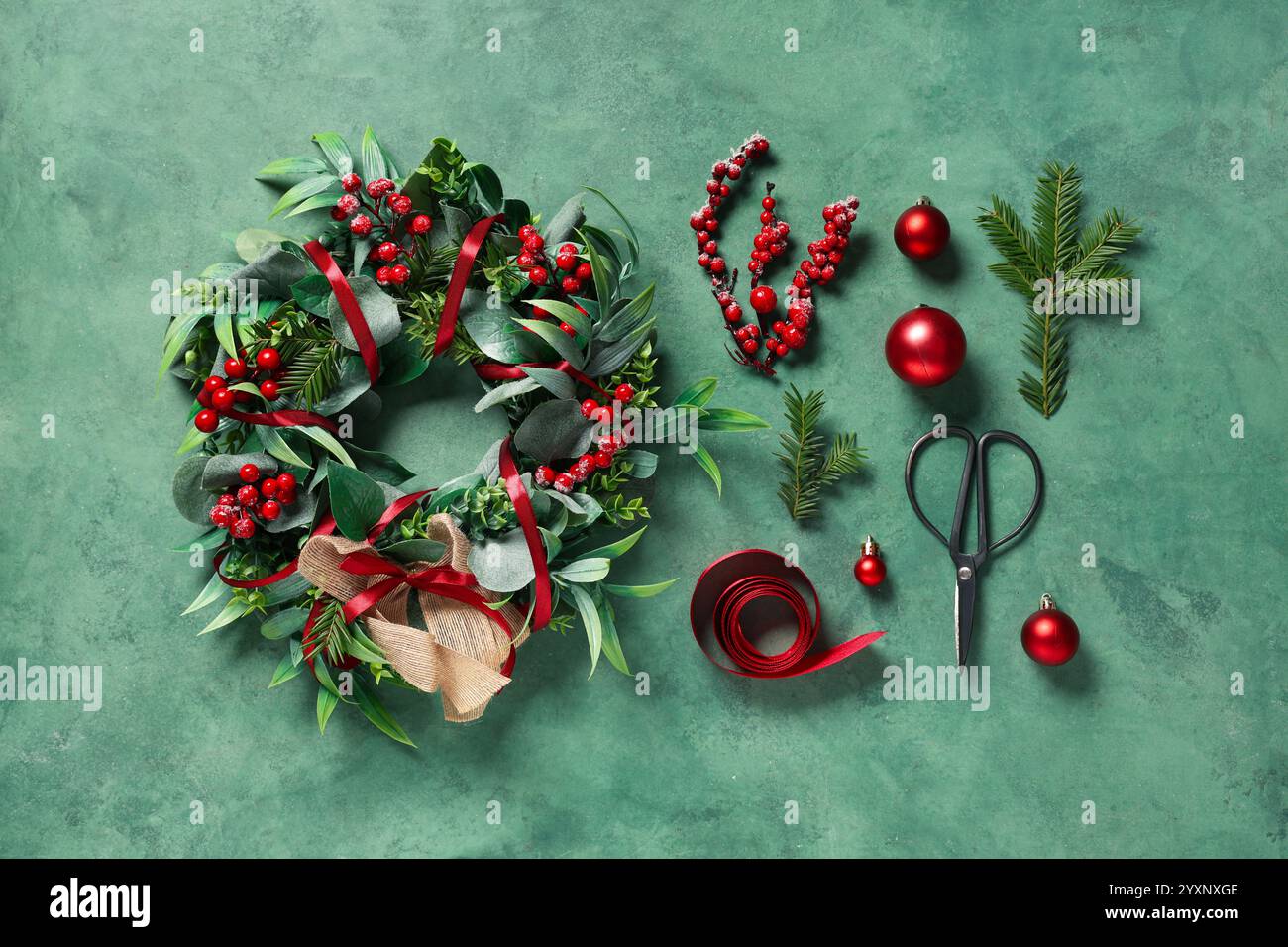 Beautiful mistletoe wreath with viburnum, decorations and supplies on ...