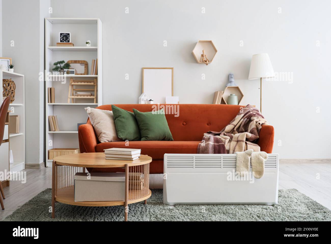 Interior of stylish living room with modern convector heater and brown ...