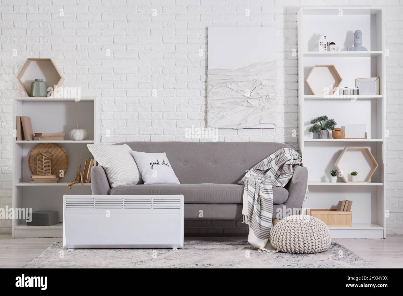 Interior of stylish living room with modern convector heater and grey ...