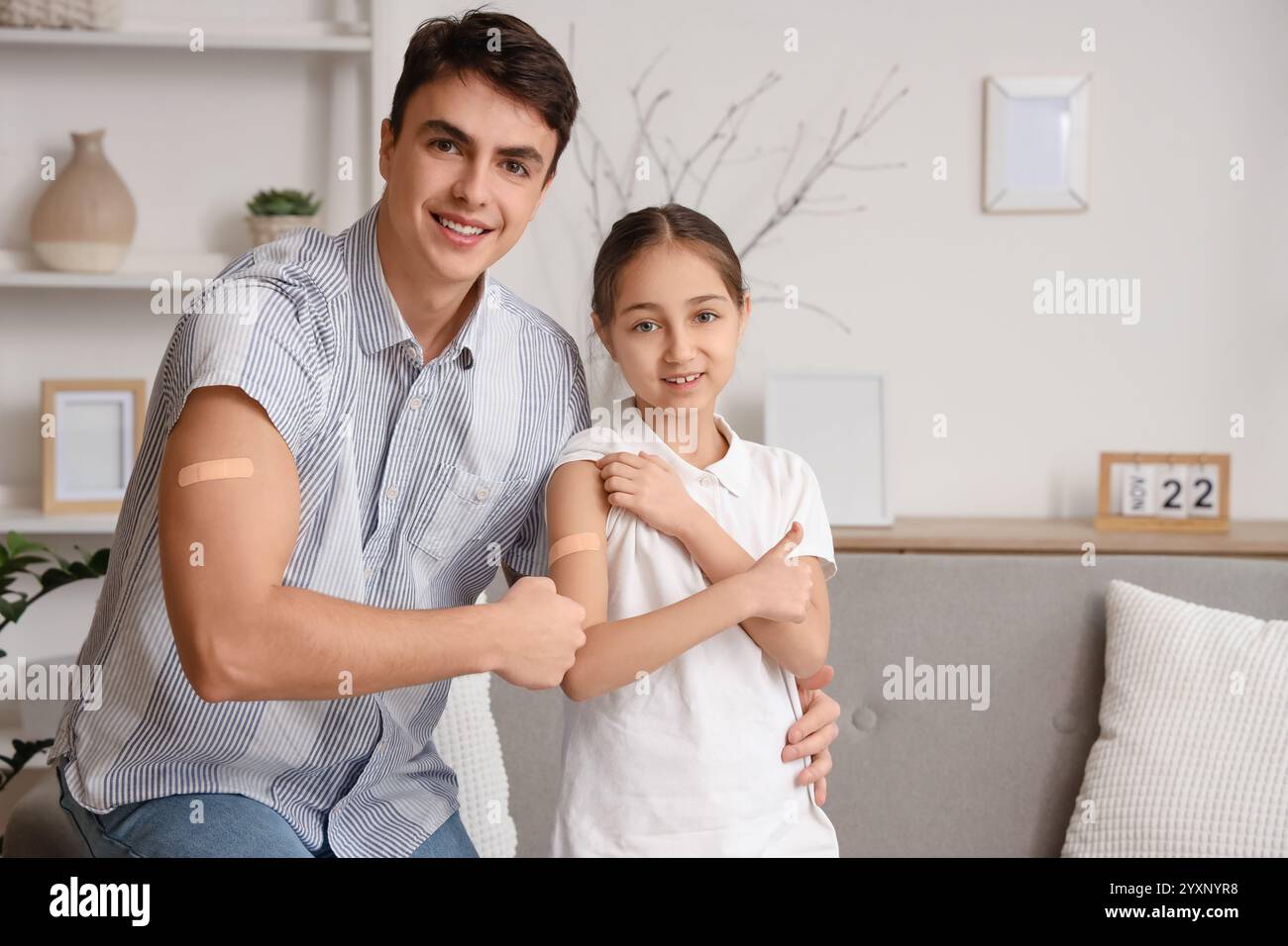Happy father and his daughter with medical patches after vaccination at ...