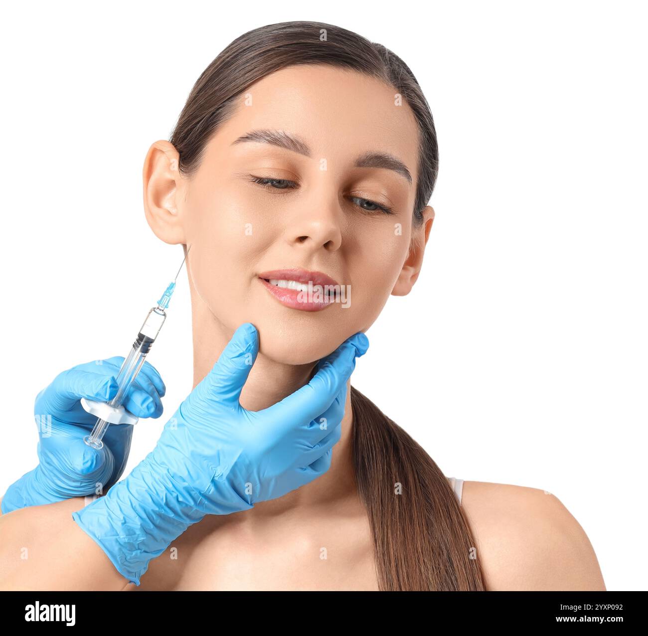 Young girl receiving filler injection in face against white background ...