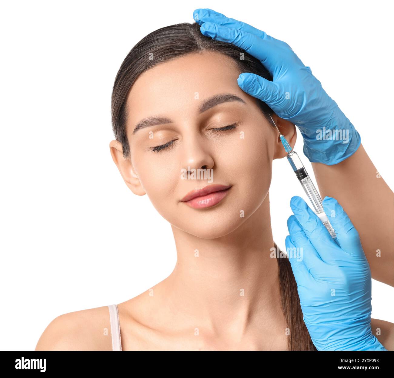 Young girl receiving filler injection in face against white background ...