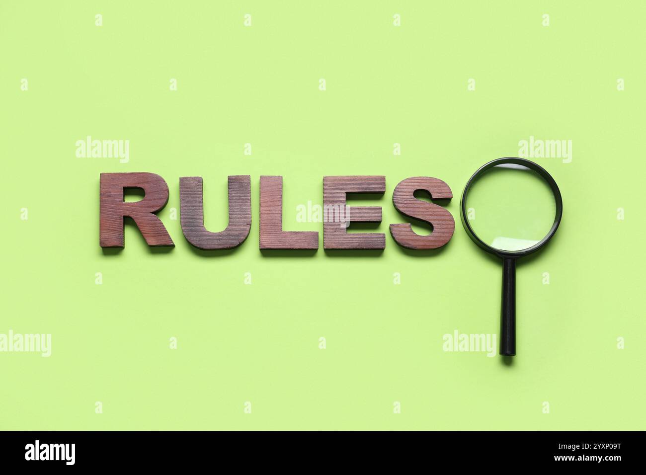 Word RULES with magnifier on green background Stock Photo - Alamy
