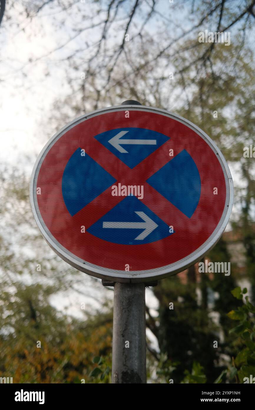A red and blue sign with an arrow pointing to the left and another ...