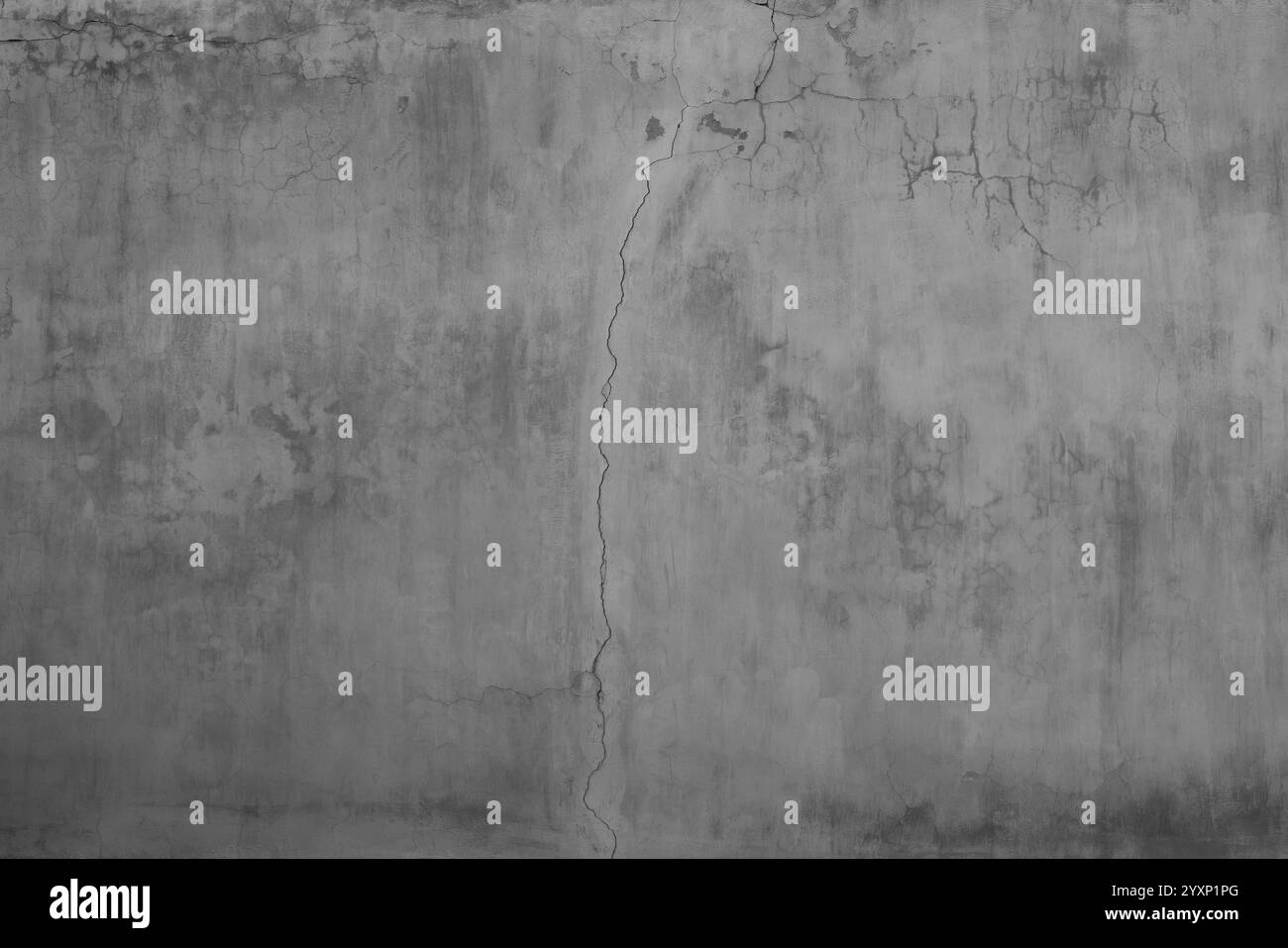 Weathered gray concrete wall background featuring visible cracks and a ...