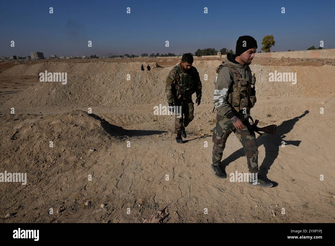 Syrian fighters from a rebel group, arrive at a location identified as ...
