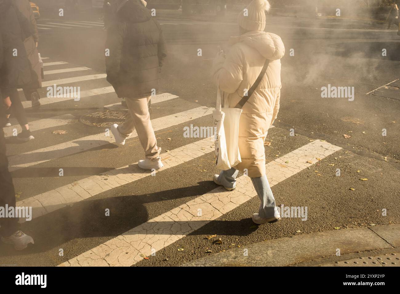 New York city commuters walk briskly to work on a bitterly cold morning ...