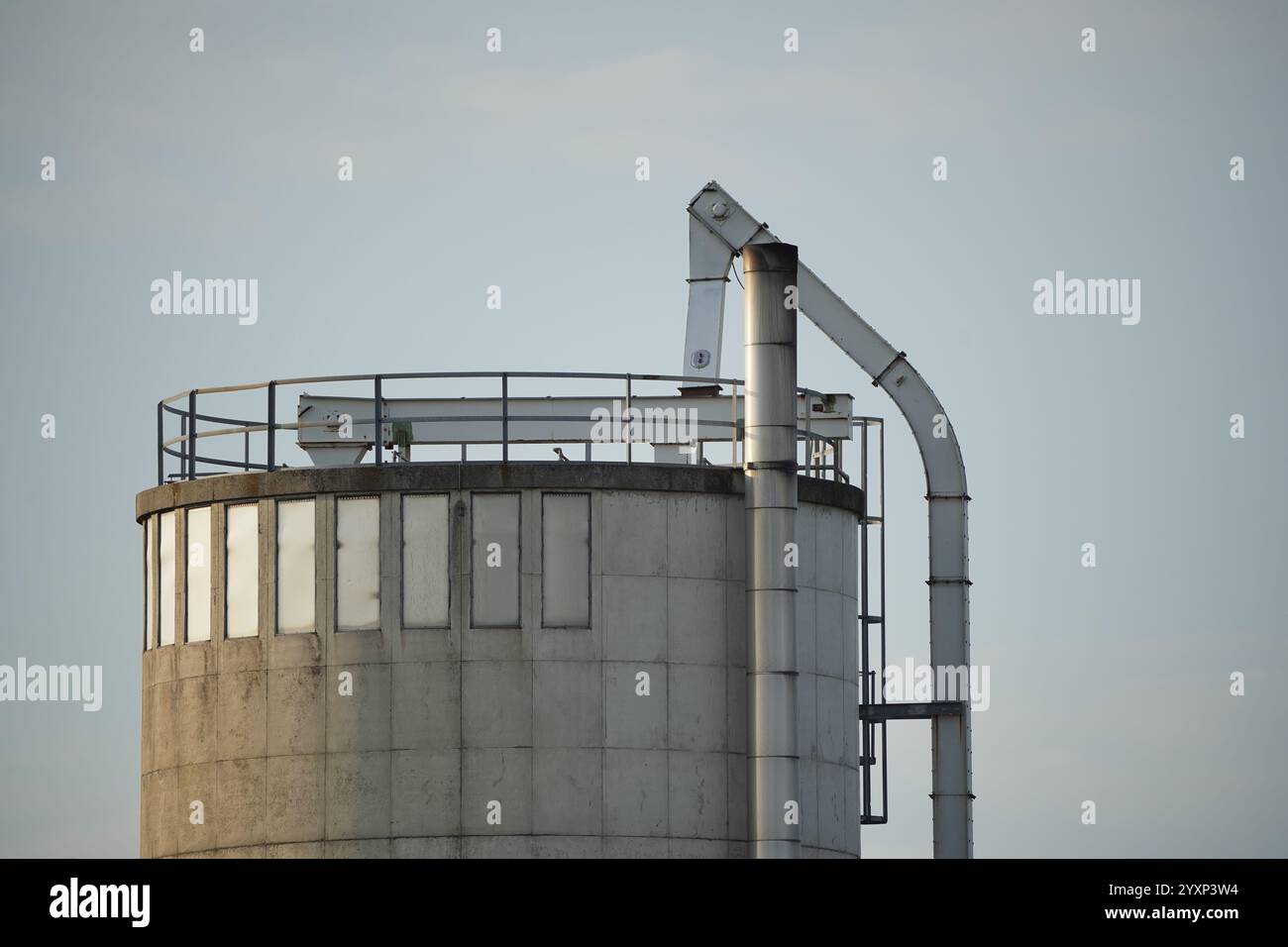 A large gray tank with a white pipe sticking out of it. The tank is ...