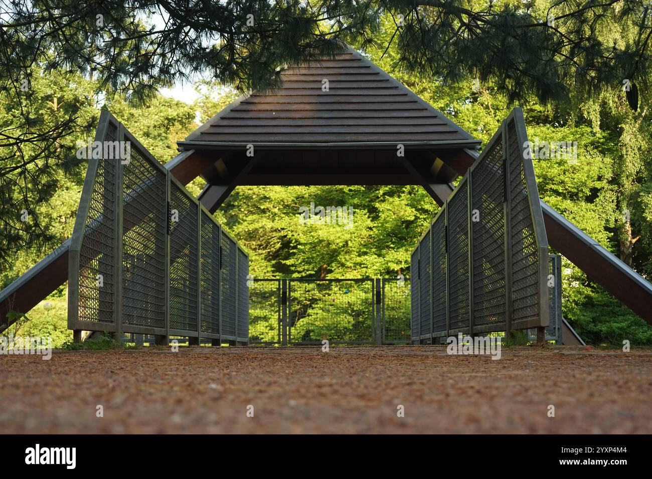 A bridge with a roof over it and a gate in the middle. The gate is open ...