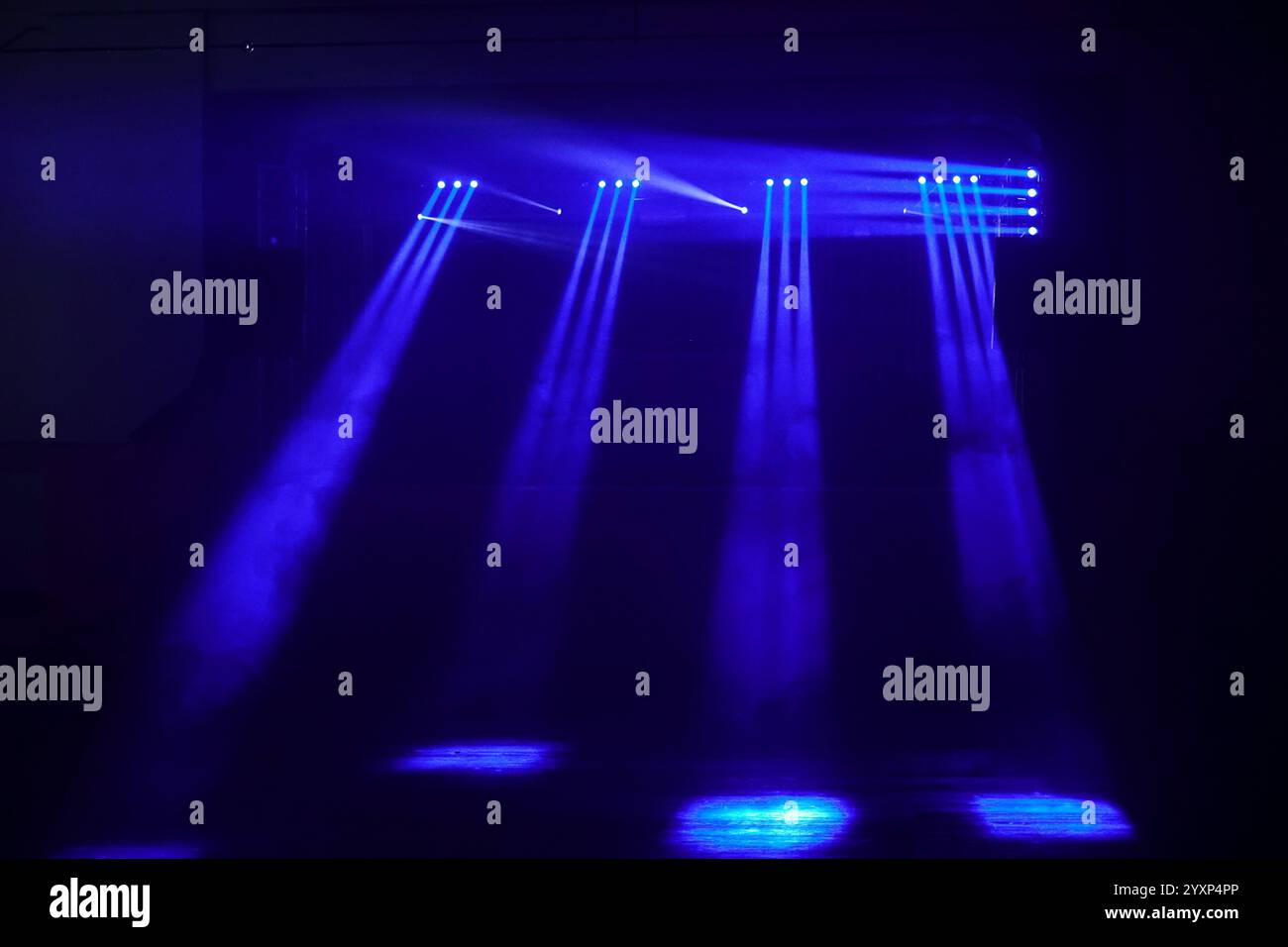 A blue light show with four lights. The lights are blue and are ...
