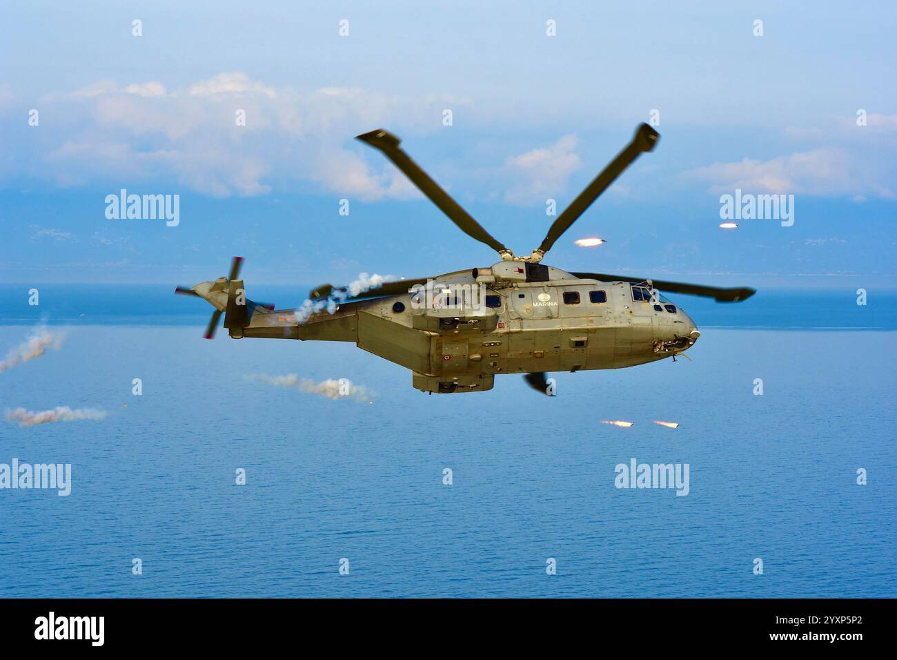 Italian Navy MH-101A helicopter firing flares during a training flight ...