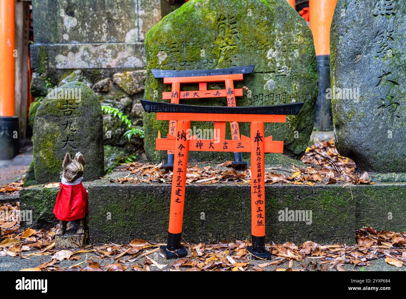 Small shinto place of worship with Torii Gates and inscriptioned stones ...