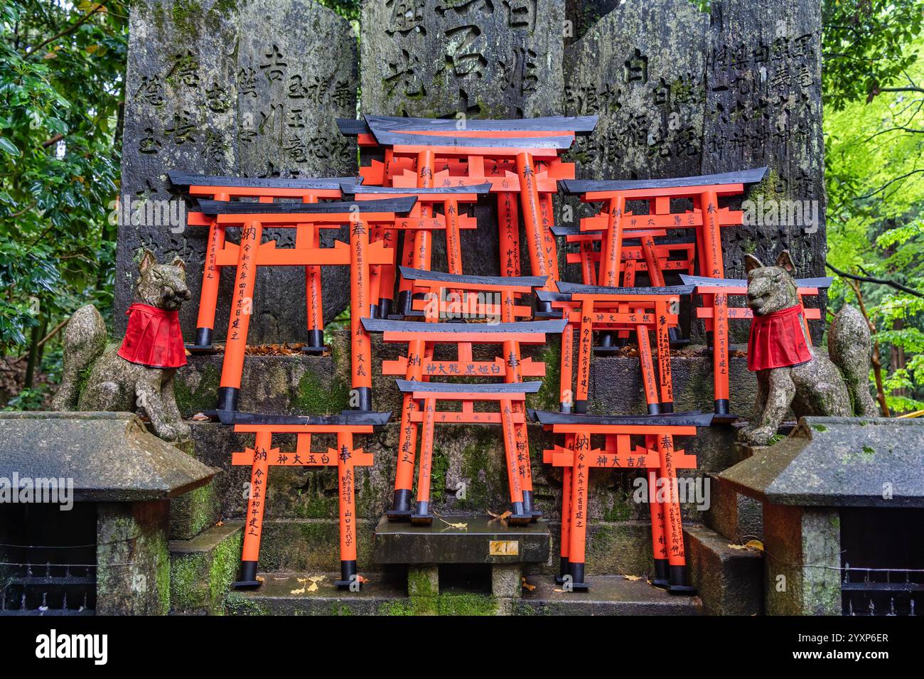 Small shinto place of worship with Torii Gates and inscriptioned stones ...