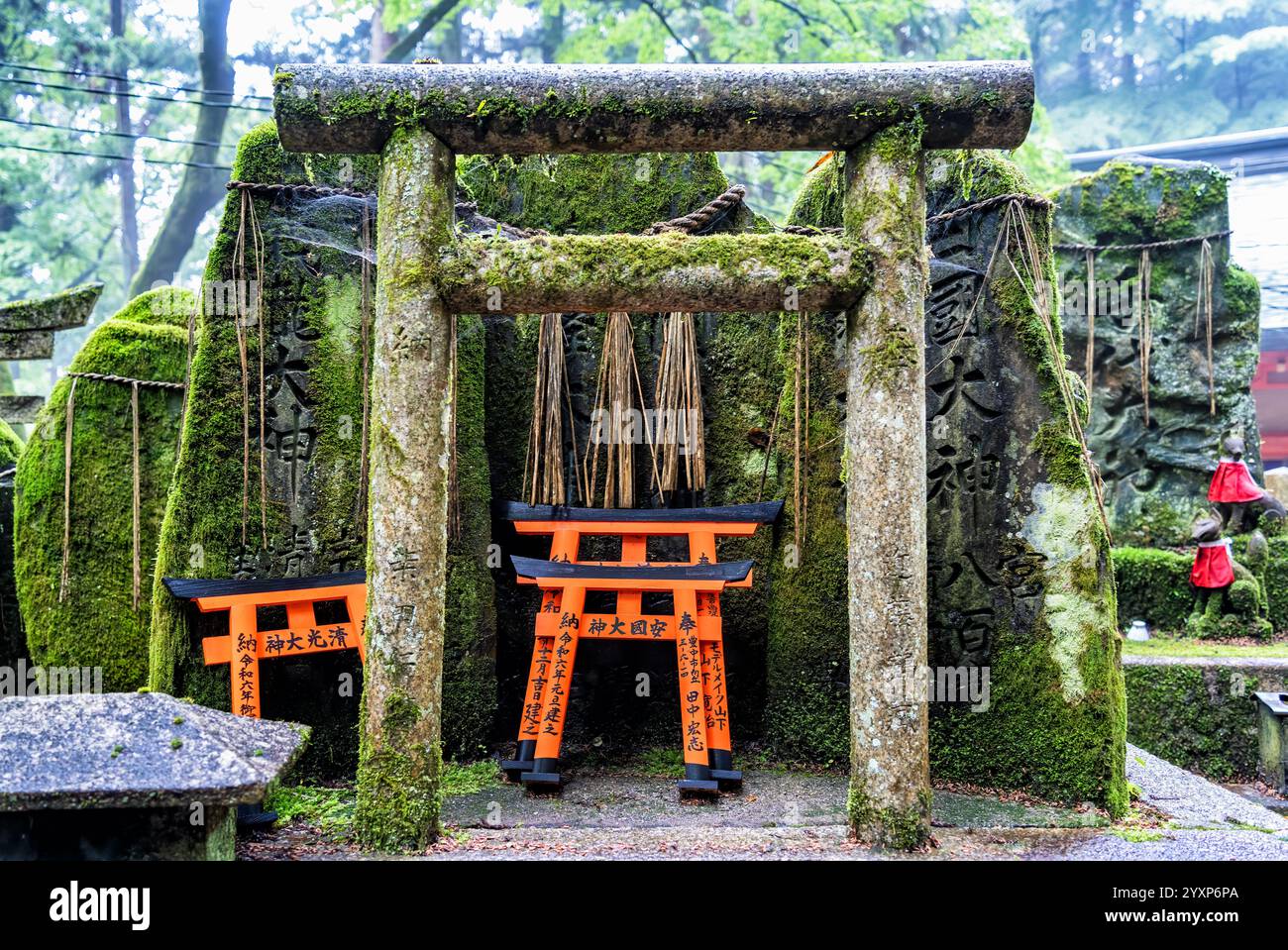 Small shinto place of worship with Torii Gates and inscriptioned stones ...
