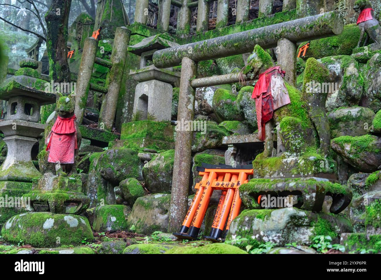 Small shinto place of worship with Torii Gates and inscriptioned stones ...