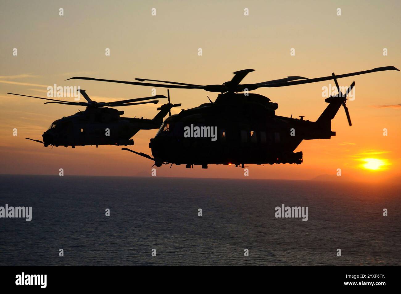 Italian Air Force HH-101A helicopters flying at sunset Stock Photo - Alamy