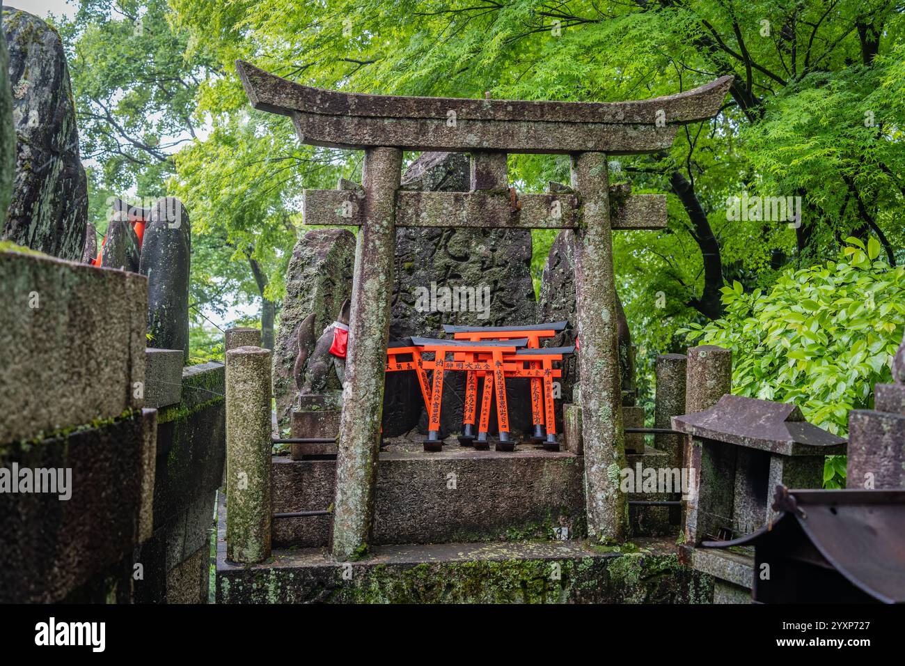 Small shinto place of worship with Torii Gates and inscriptioned stones ...