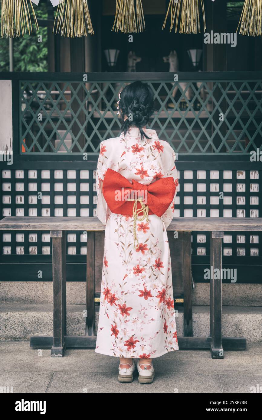 Back view with a woman wearing a traditional japanese yukata kimono ...