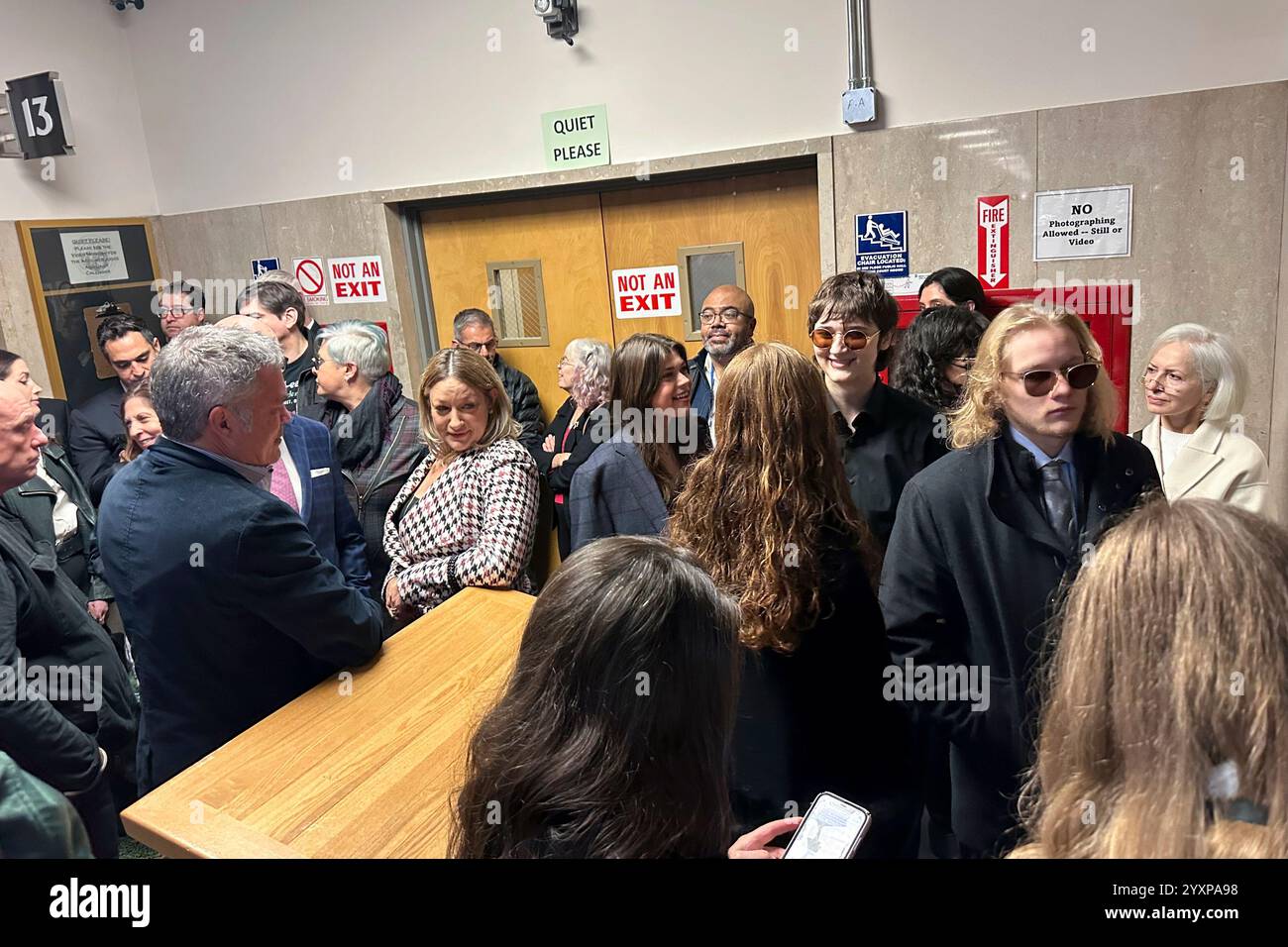 People wait in the courthouse during the murder trial of Nima Momemi ...