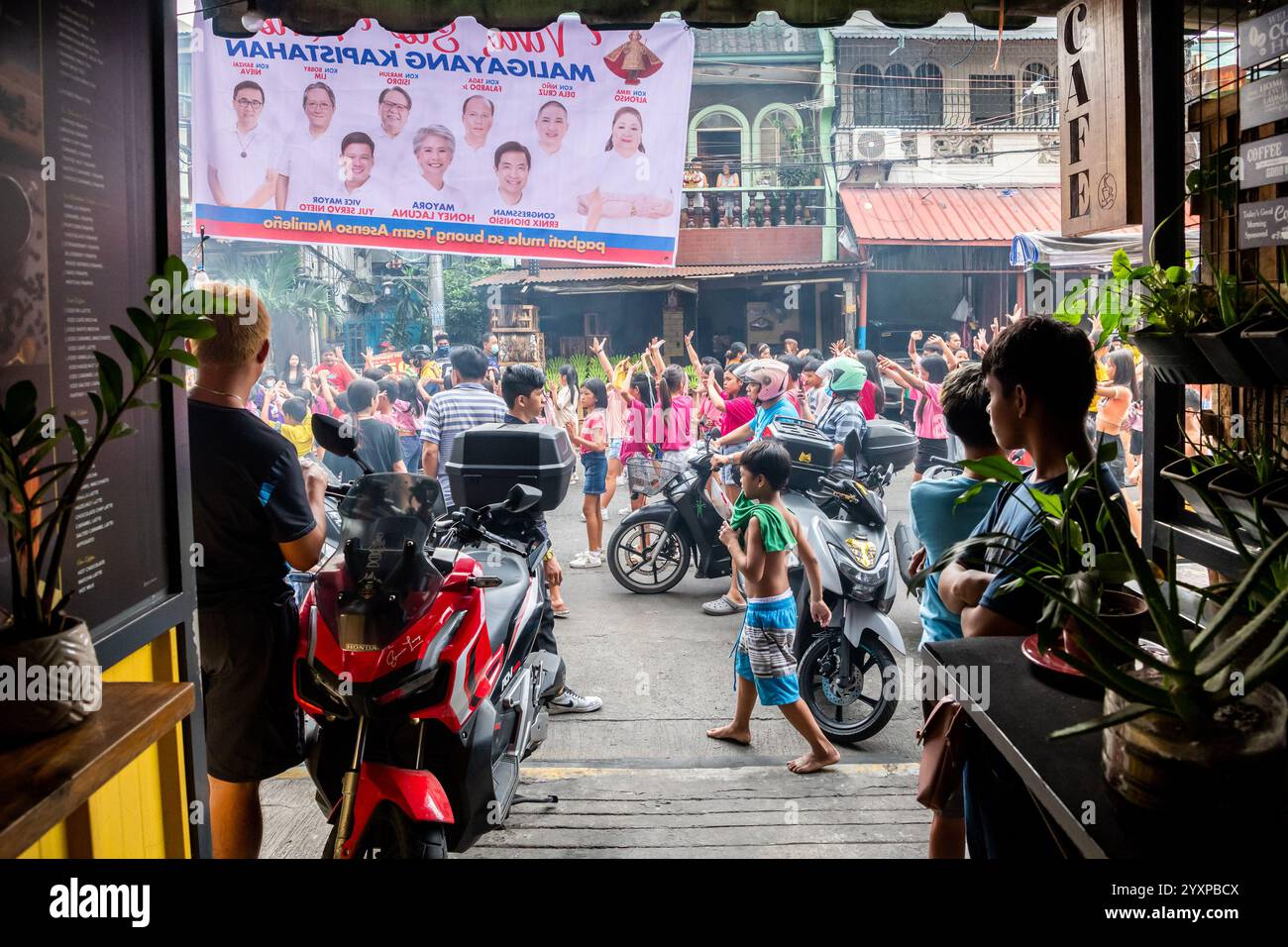 A Catholic religious parade passes by a house during an annual parade ...
