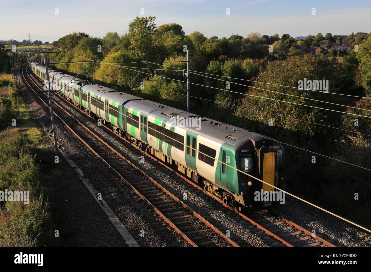 London Northwestern 350 class train, West Coast Main Line near Milton Keynes,, England. On the ...