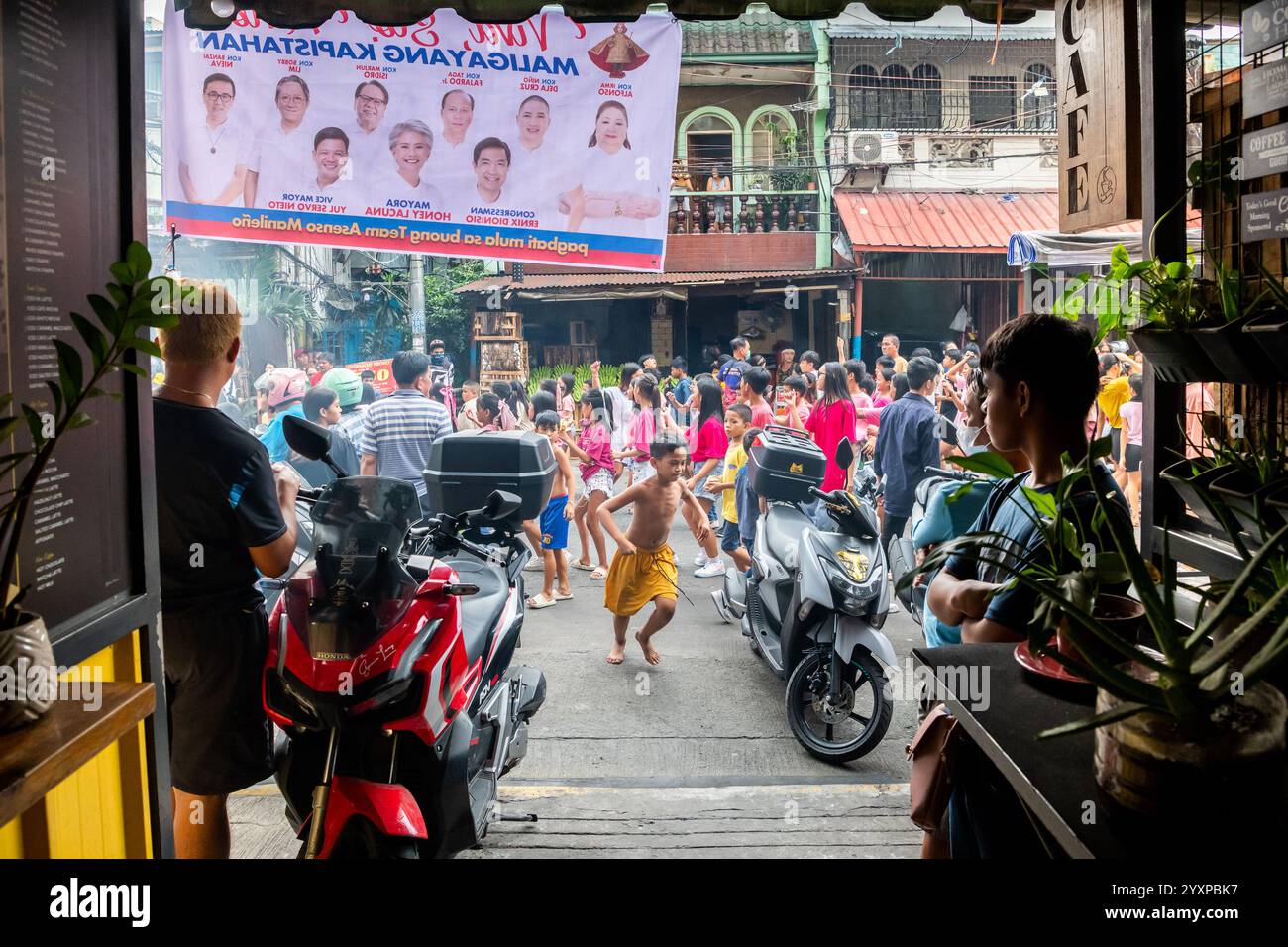 A Catholic religious parade passes by a house during an annual parade ...