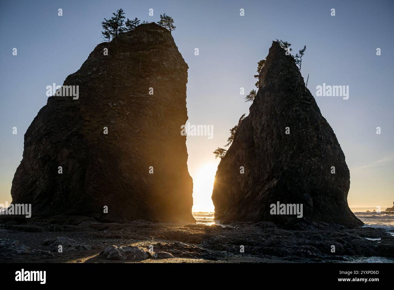 WA25971-00...WASHINGTON - Sun setting behind one of two seastacks at ...