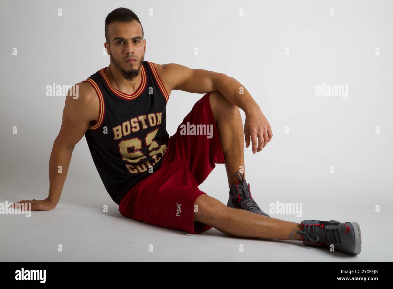 Man sitting in basketball kit Stock Photo - Alamy