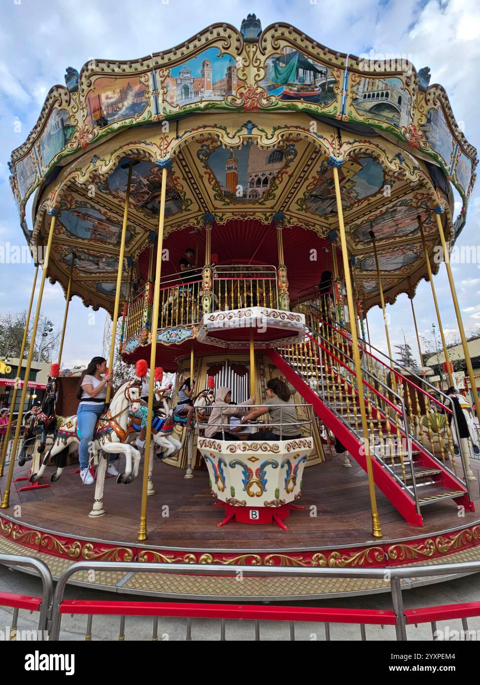 Mexico City, Mexico - Mar 20 2024: Two-story carousel with moving rides ...