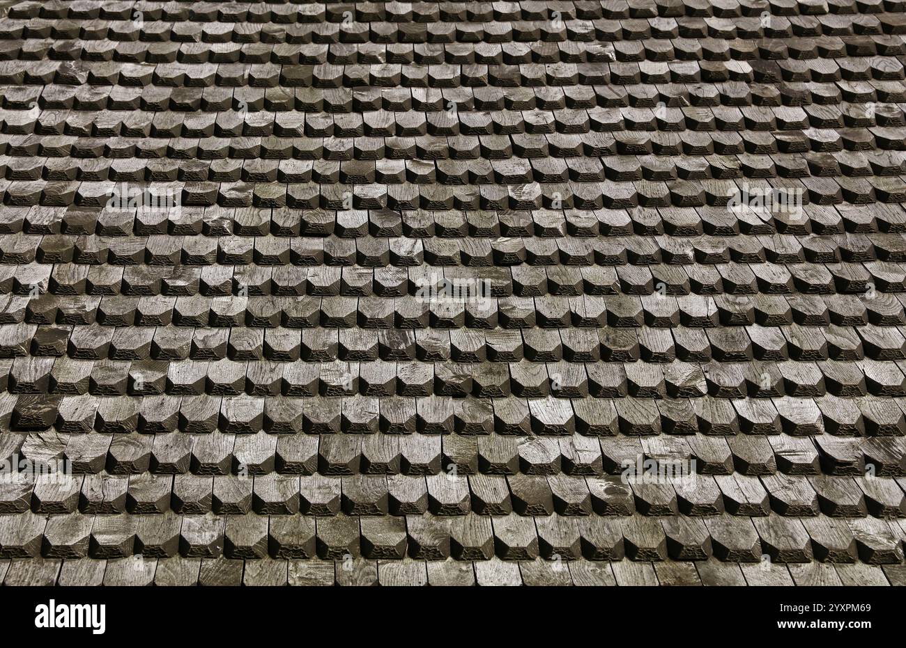Wooden roof shingles are forming a repeating pattern, adding a touch of ...
