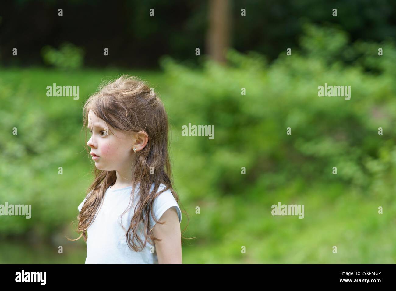 Little cute sad girl walking in summer park. Concept of sad child ...