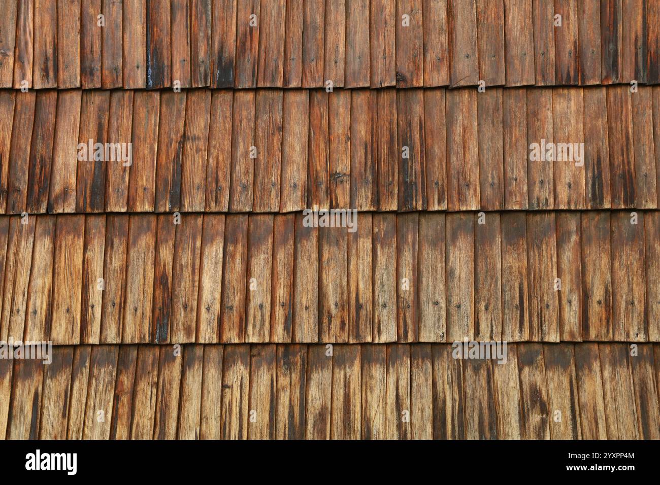 Close up view of overlapping old wooden shingles forming a textured ...