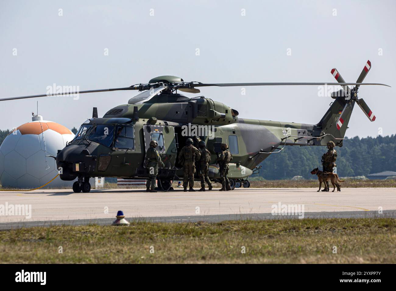 Infantrymen of the German Army prepare to board a NH-90 transport ...