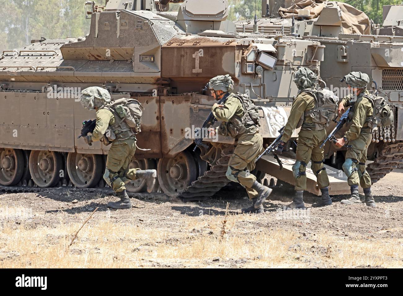 Infantry soldiers disembark from a Namer APC of the Israel Defense ...