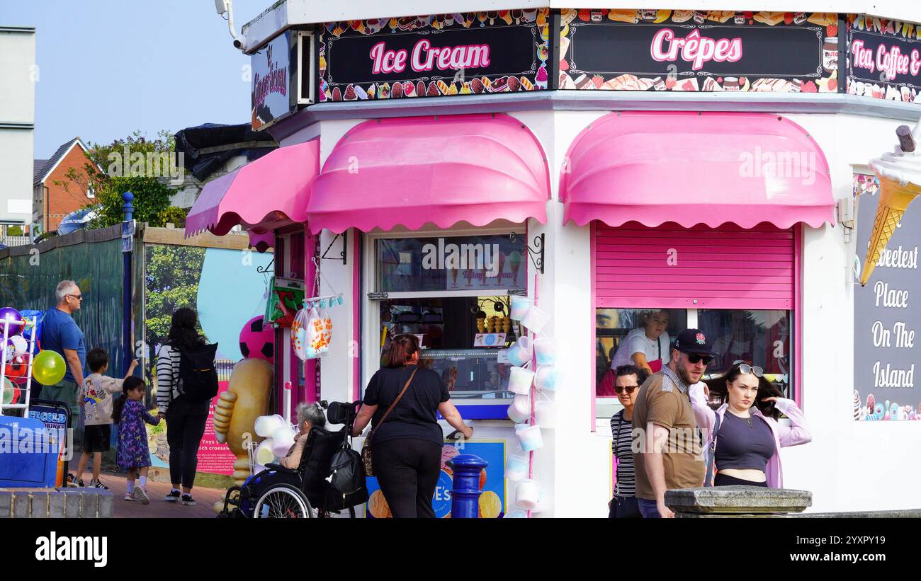 A brightly coloured pink and white ice cream parlour, kiosk, on the ...