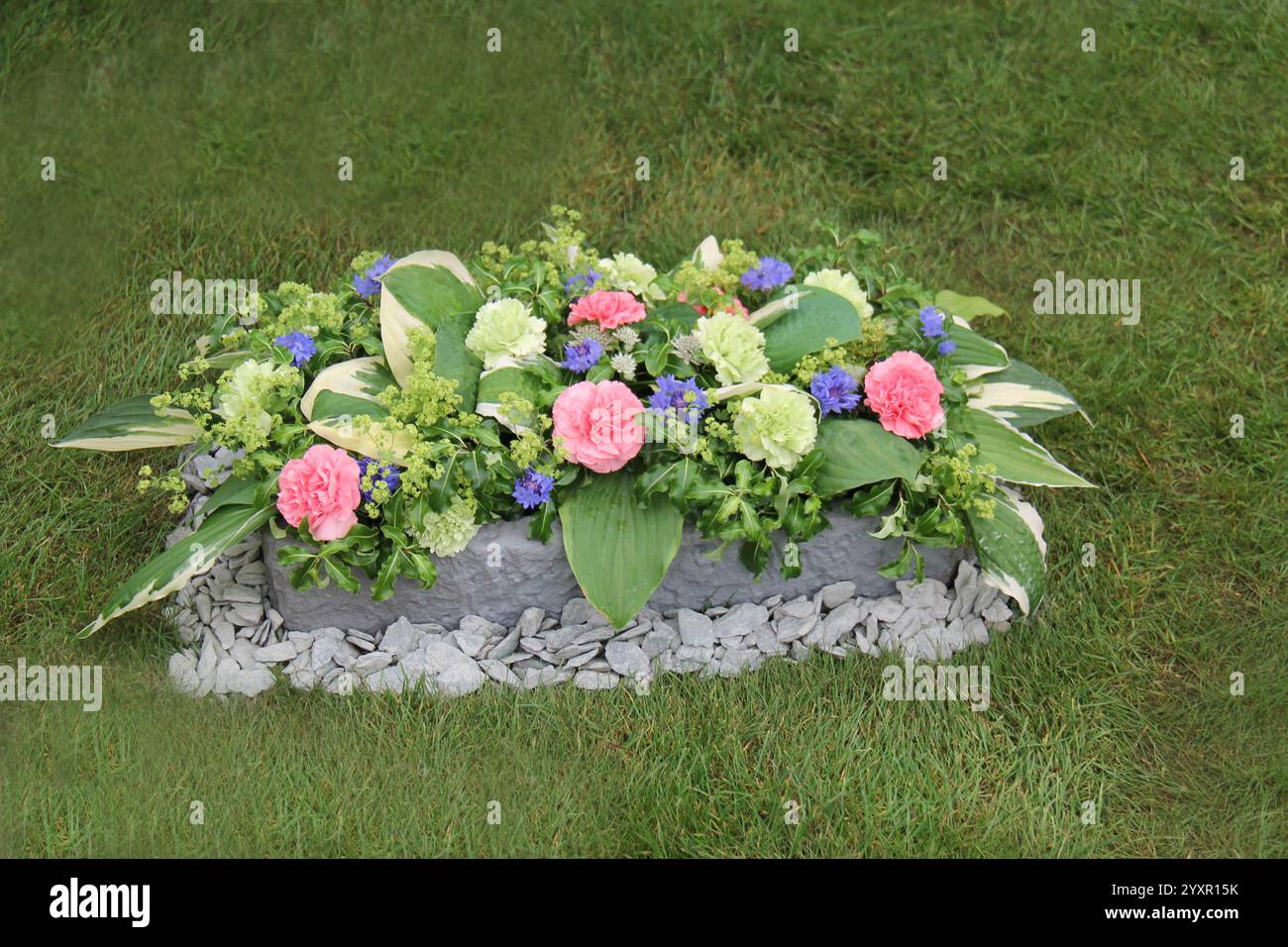 A Beautiful Flower Display in a Stone Garden Planter Stock Photo - Alamy