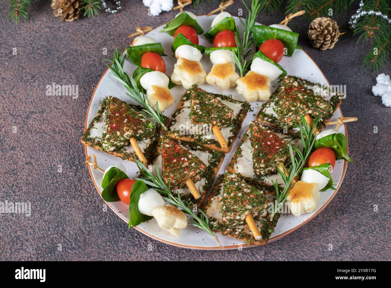 Cheese Christmas trees on crackers and canapes with cherry tomatoes ...