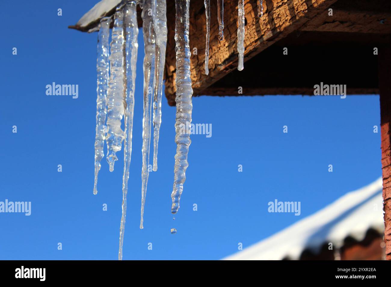 Winter icicles on the roof of the house Stock Photo - Alamy