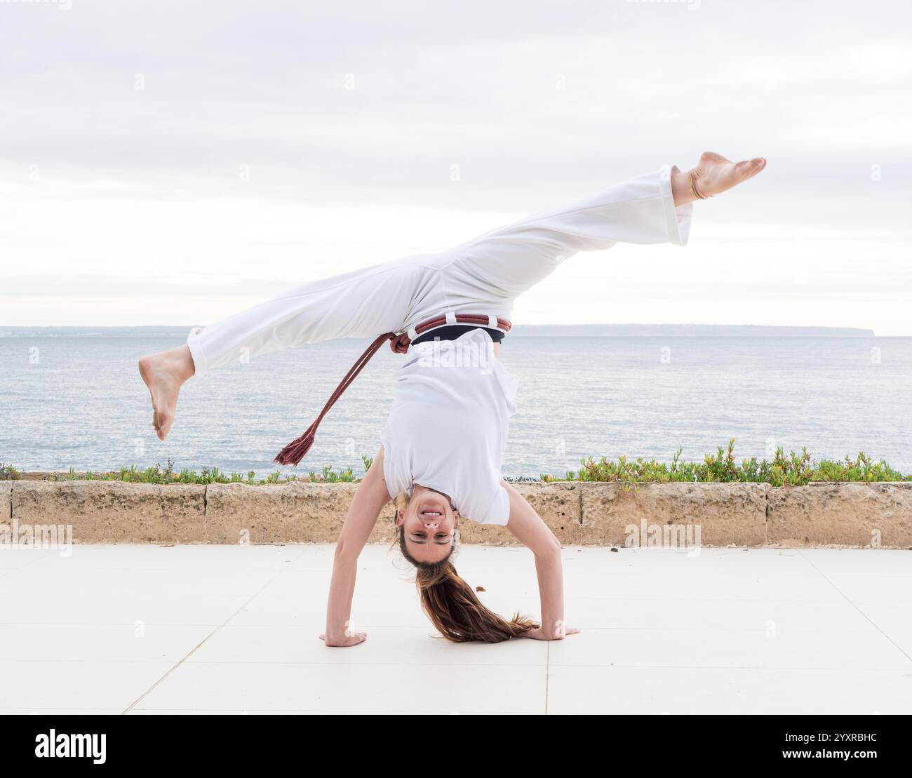 Woman Performing a capoeira Handstand Outdoors Near the ocean Stock ...