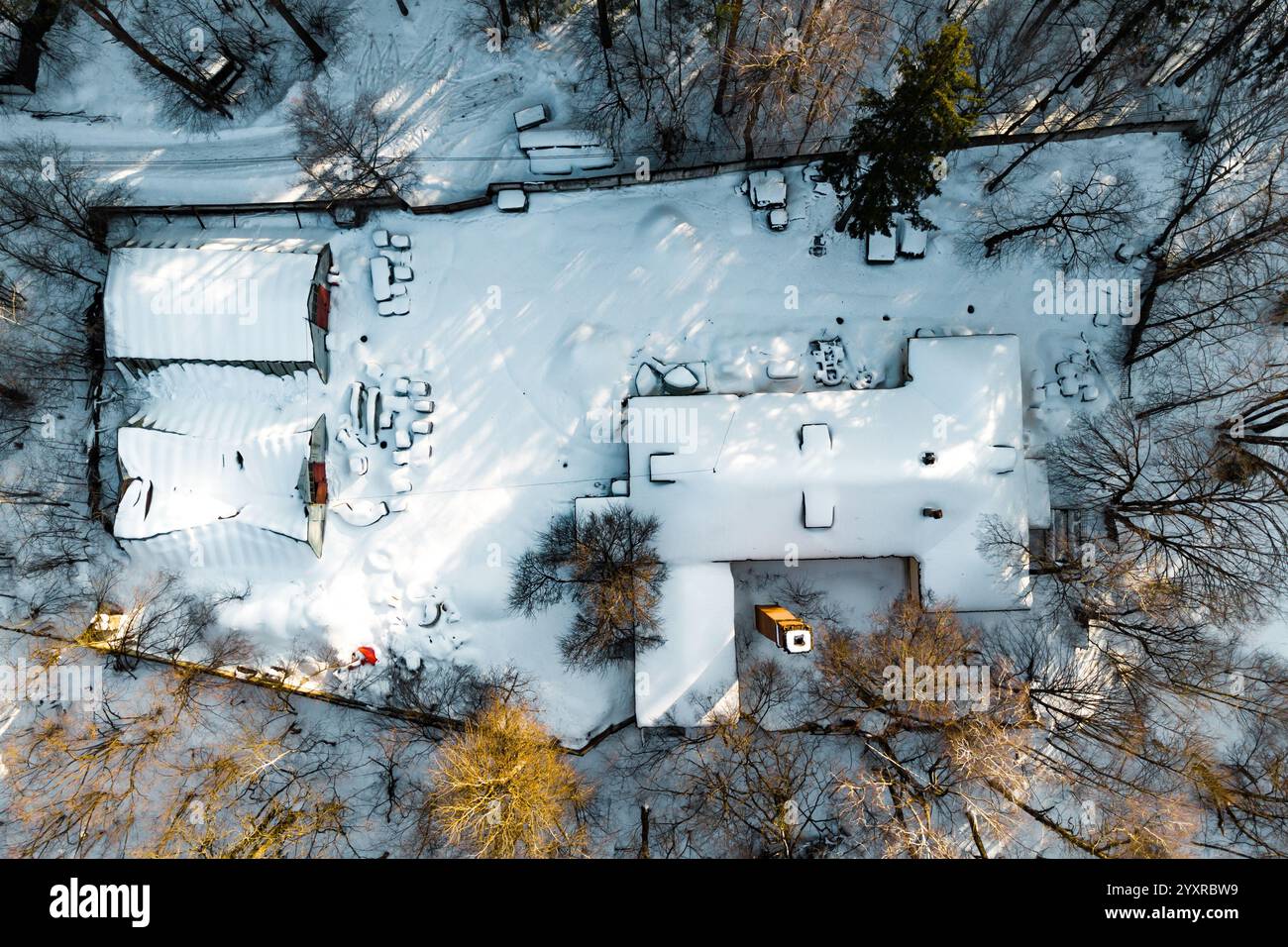 Unused industrial area with warehouses covered with snow, aerial view ...