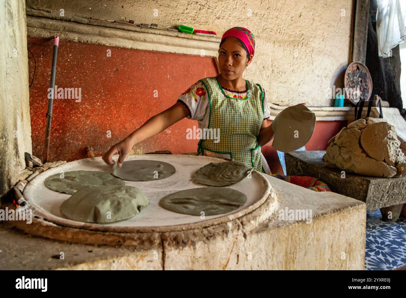 Traditional way to make tortillas at a hotplate. Santa María del Tule ...